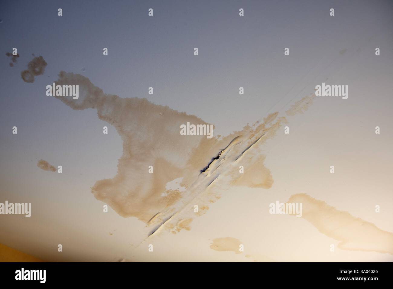 Water damage creates stains and cracks on interior ceiling in a ...