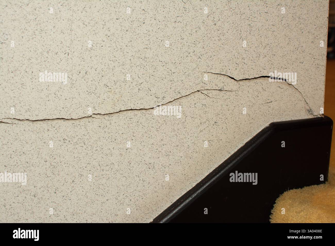 Significant crack visible on an interior wall near a staircase in a ...