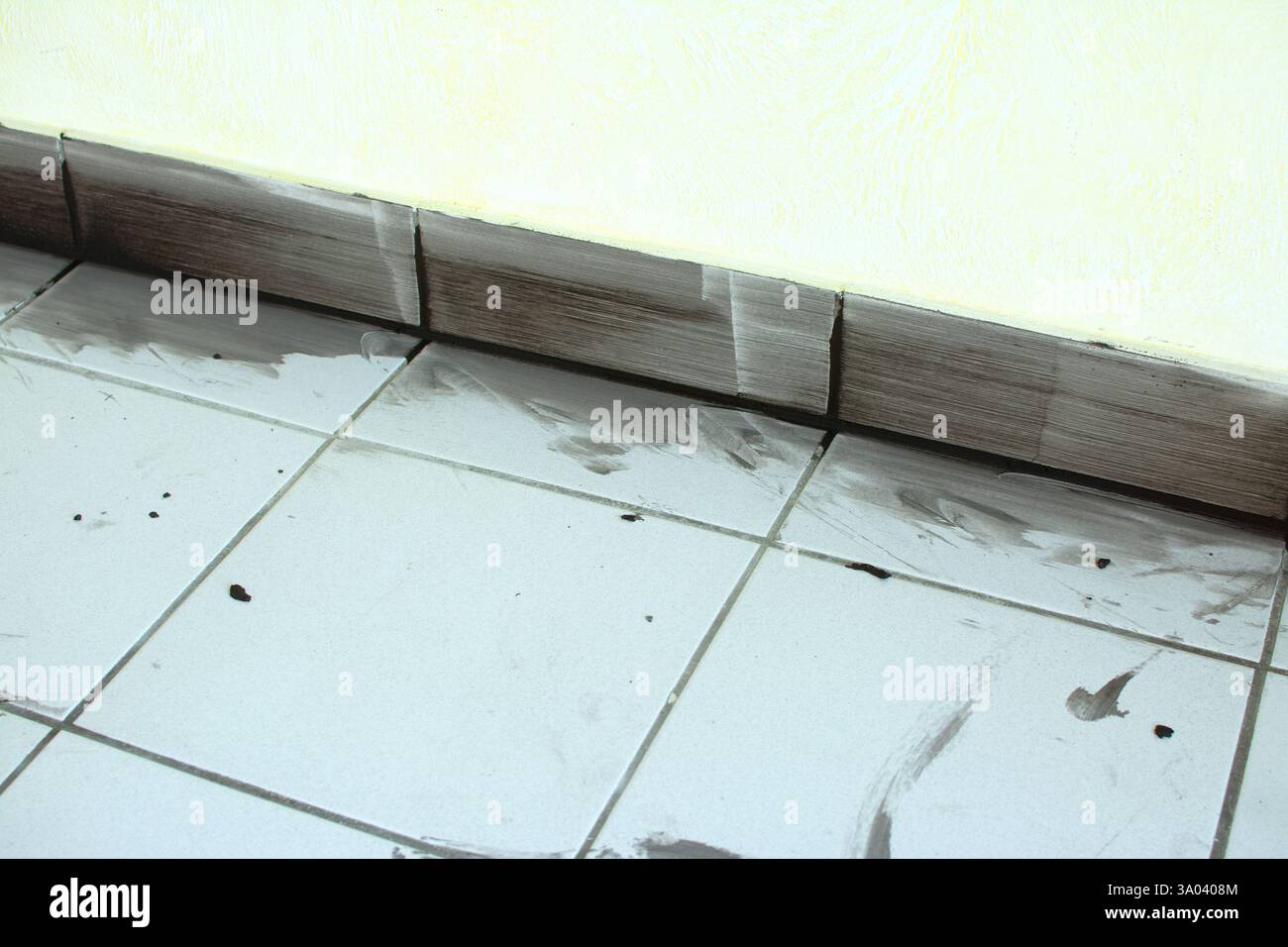 Cleaning process of dirty tile flooring with significant mess evident ...