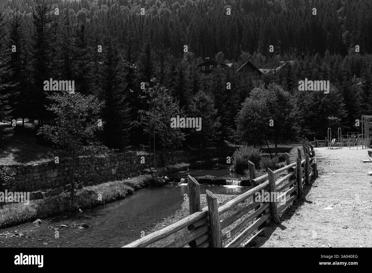 Wooden Fence Lining a Stream Through a Forested Village Stock Photo - Alamy