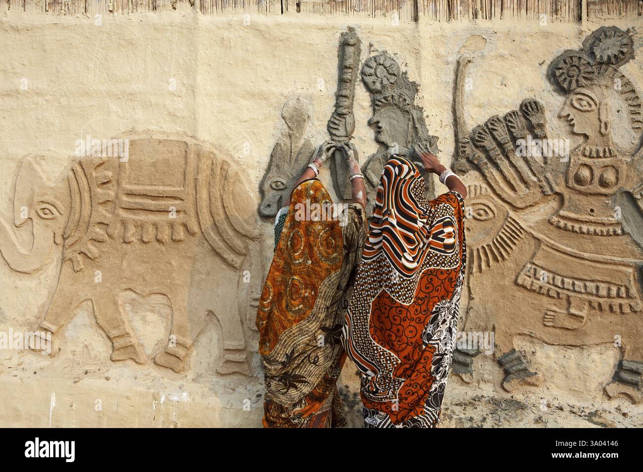 Women creating mud relief art on wall Madhubani Bihar India Asia Stock ...