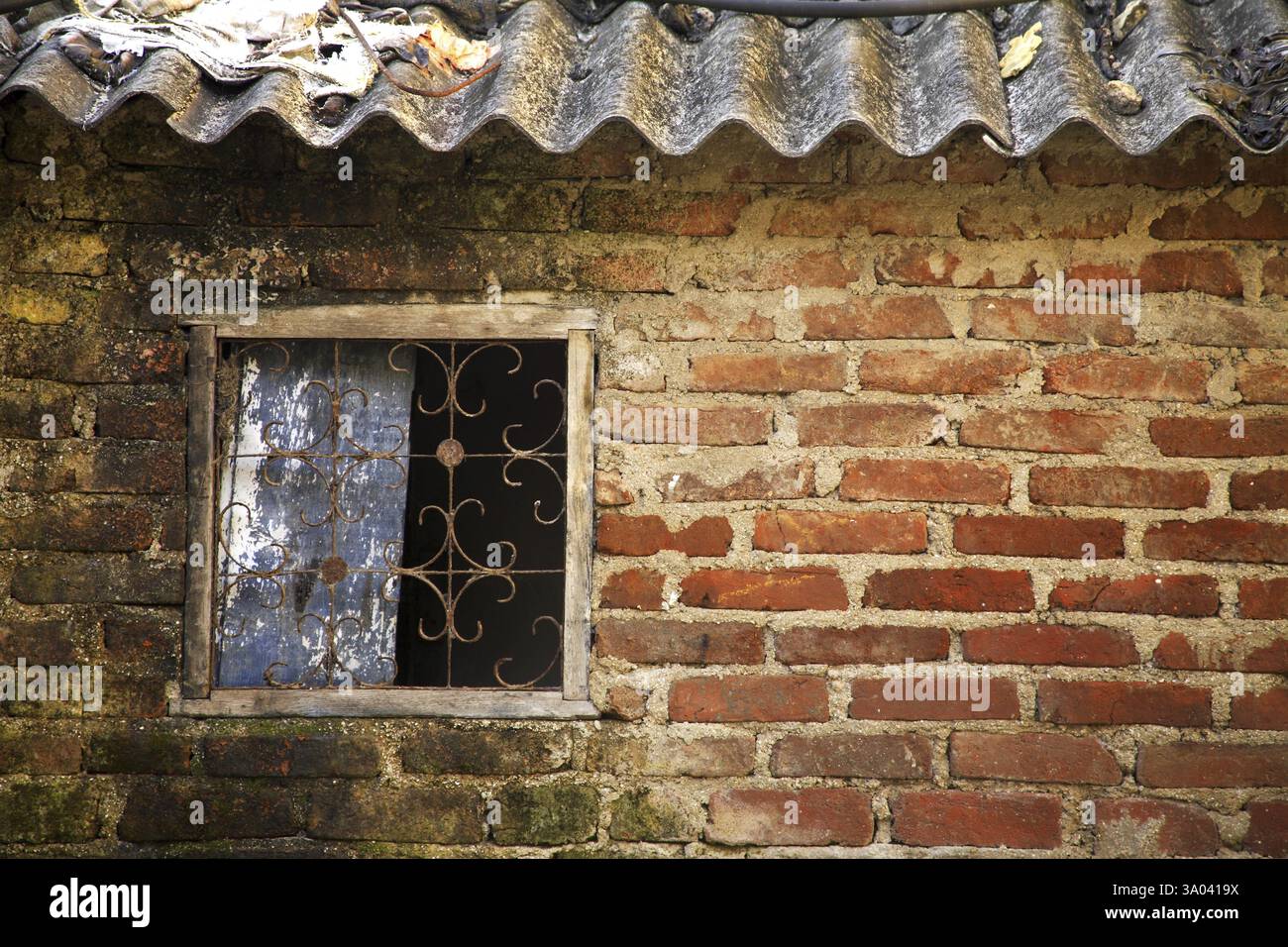 Brick wall and window in slum, Koliwada, Manori Marve marg, Malad ...
