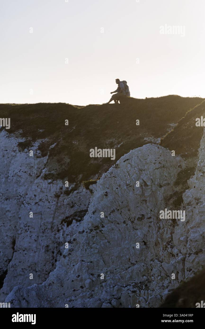 Walkers enjoying views of cliffs, chalk coast, backlight, Beachy Head ...