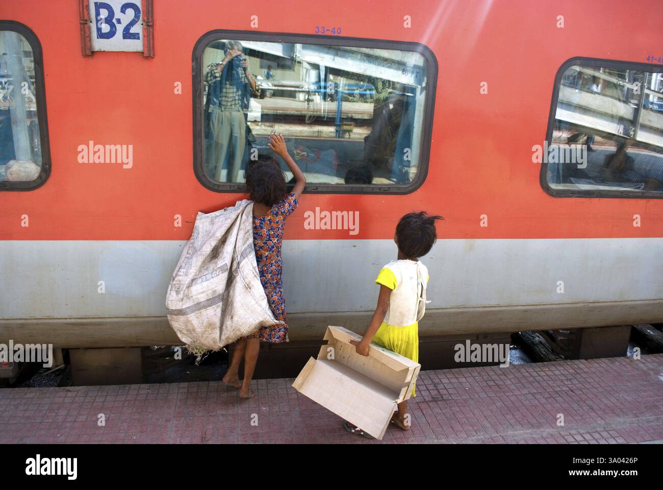 Rag picker children looking at window of rajdhani express train ...