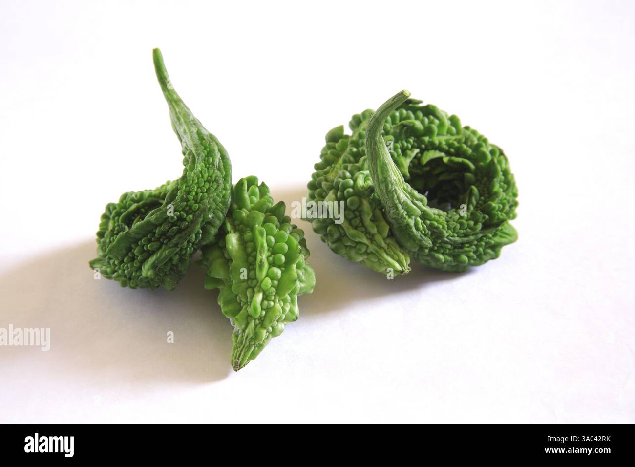 Green vegetable, karela bitter gourd momordica charantia on white ...
