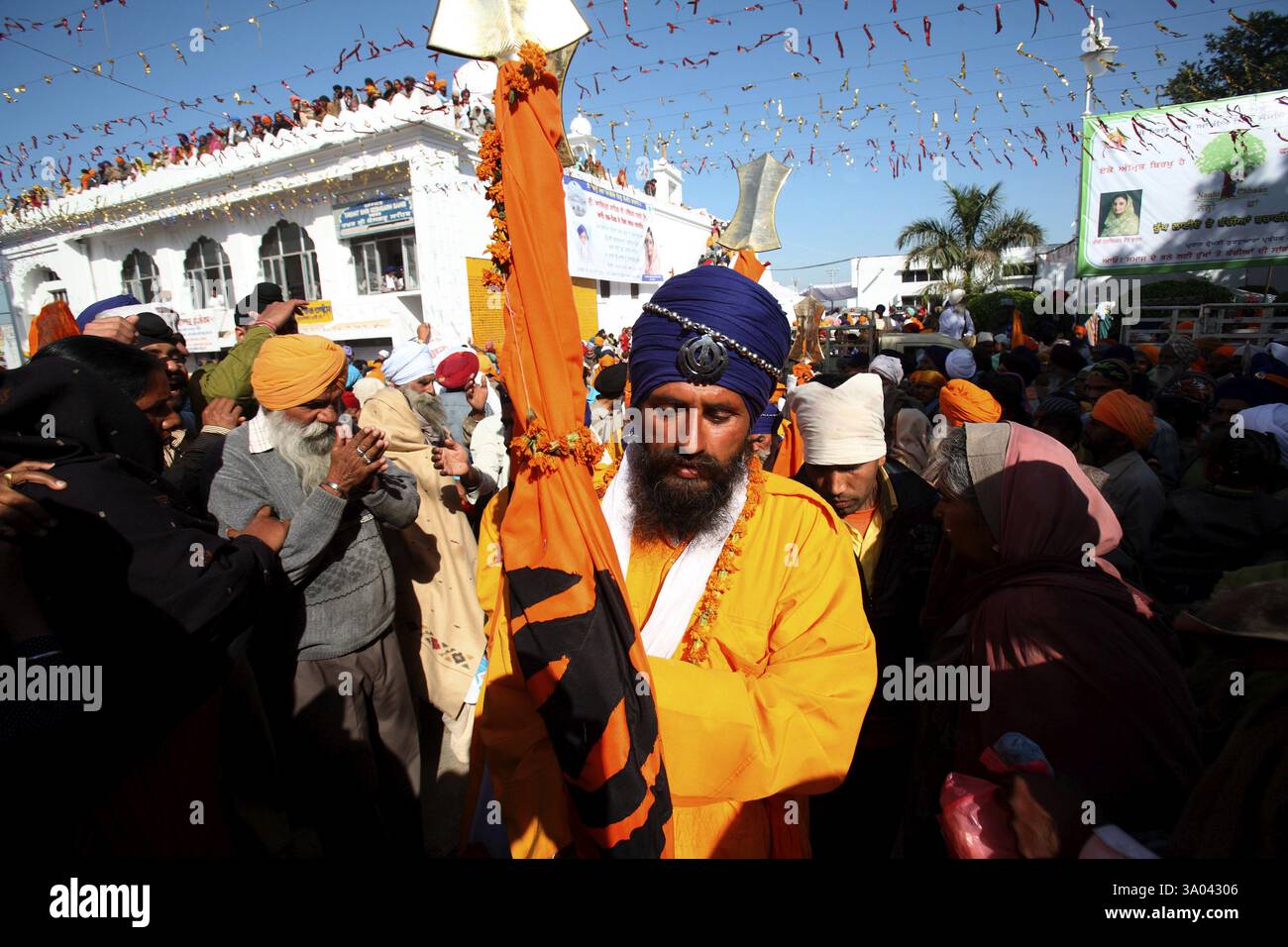 Sikh devotee carrying nishansahib holy flag during procession of Hola ...