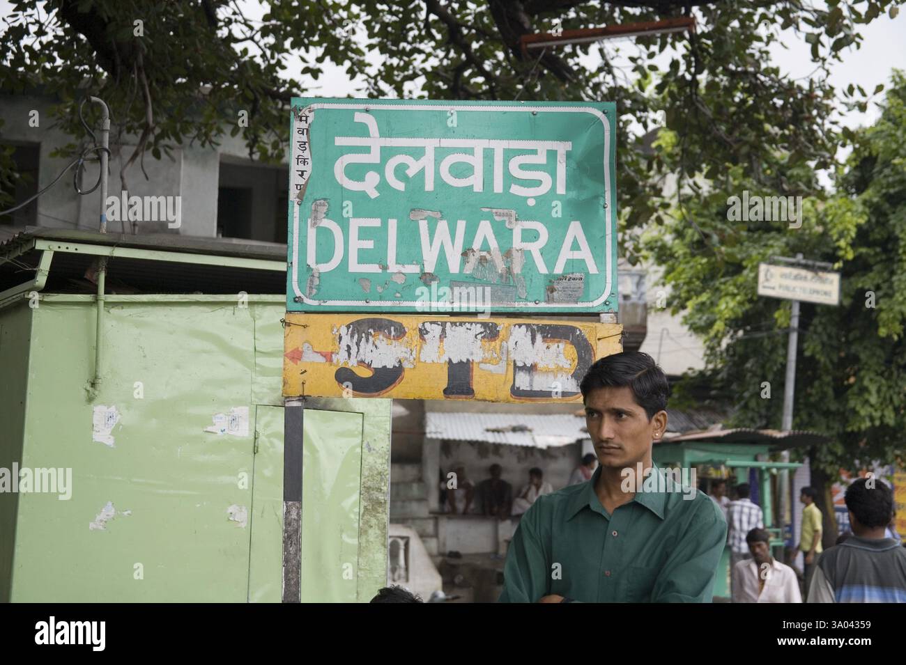 Man standing near the sign board, Village Delwara, Udaipur, Rajasthan ...