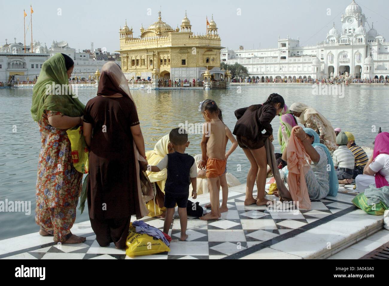 Sikh devotees take a holy dip in Amrit sarovar the lake of nectar ...