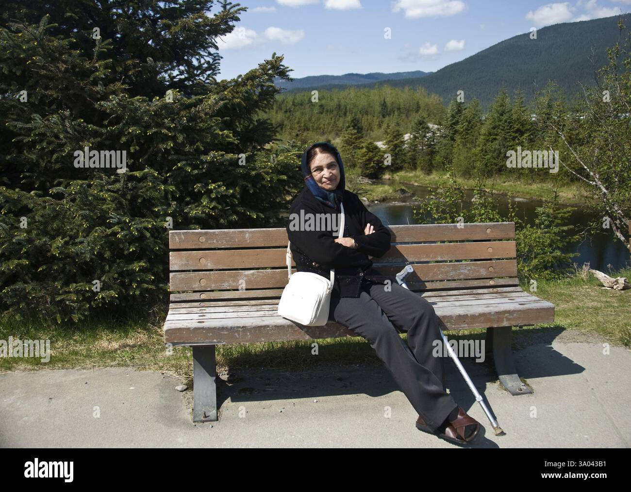 Old lady sitting on bench, Alaska, USA United States of America MR#782 ...