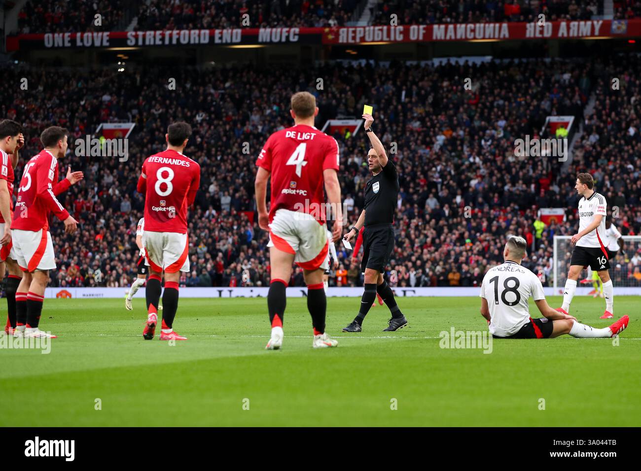 Manchester, UK. 02nd Mar, 2025. Referee Stuart Attwell shows a yellow ...
