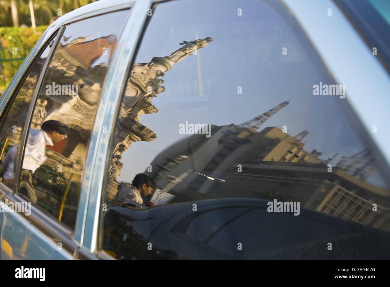 Flora Fountain and telephone exchange building reflection on car window ...