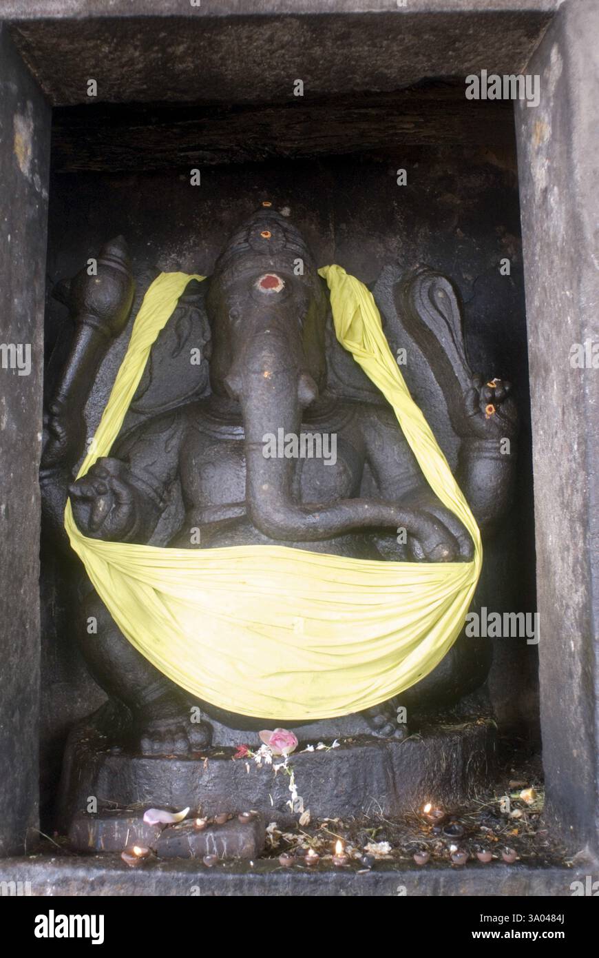 Statue of God Ganesha Ganpati wearing Yellow cloth covered at the ...