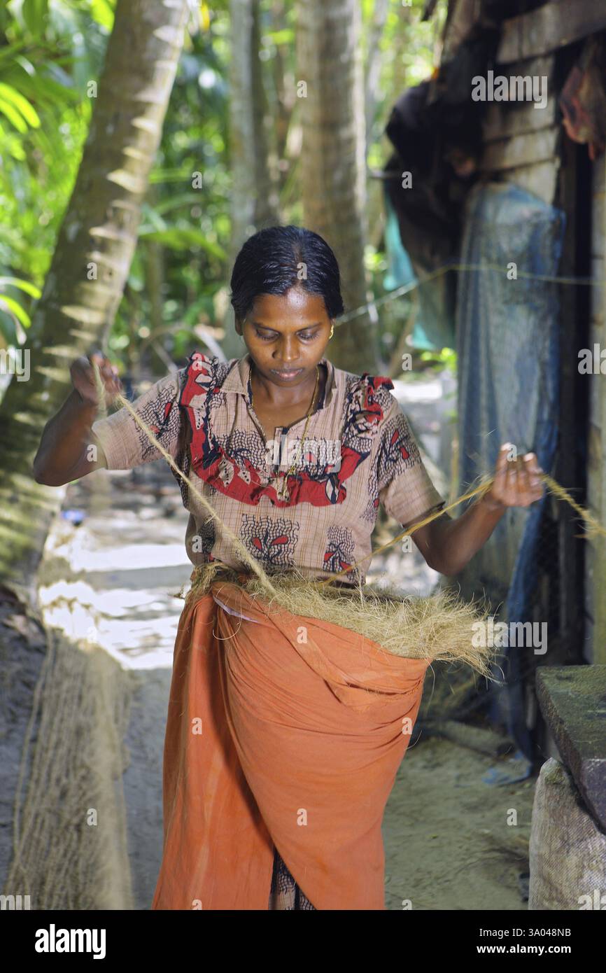 Keralite woman making coir rope in cottage, traditional method, Kerala ...