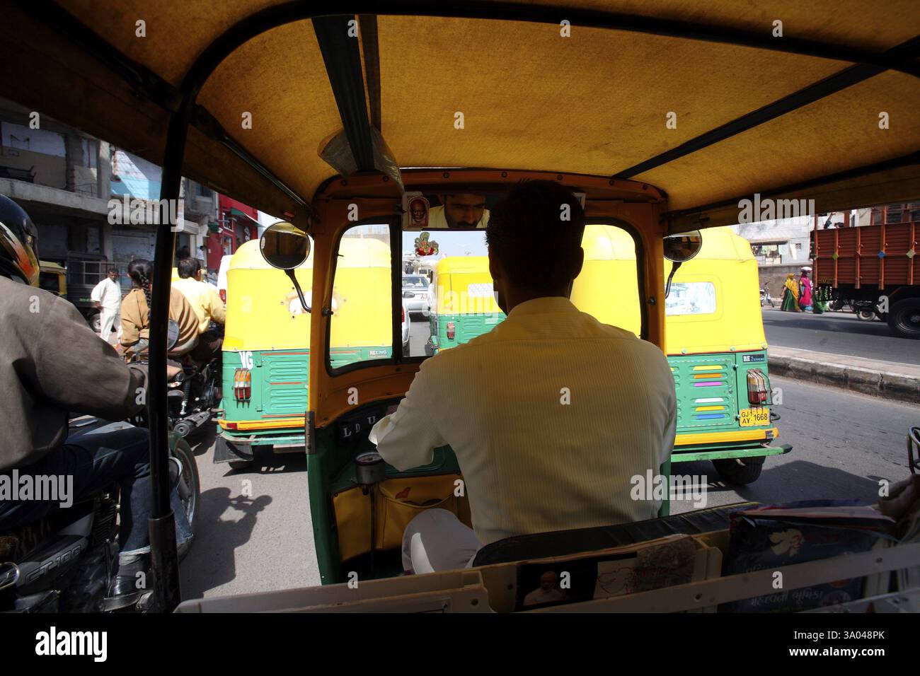 Three wheeler auto rickshaw driver on street of Ahmedabad, Gujarat ...