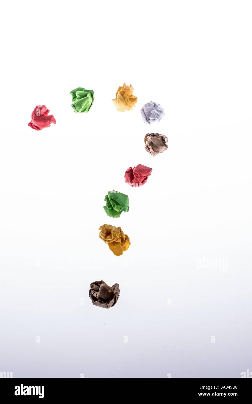 Colorful crumpled paper form a question mark on a white background ...