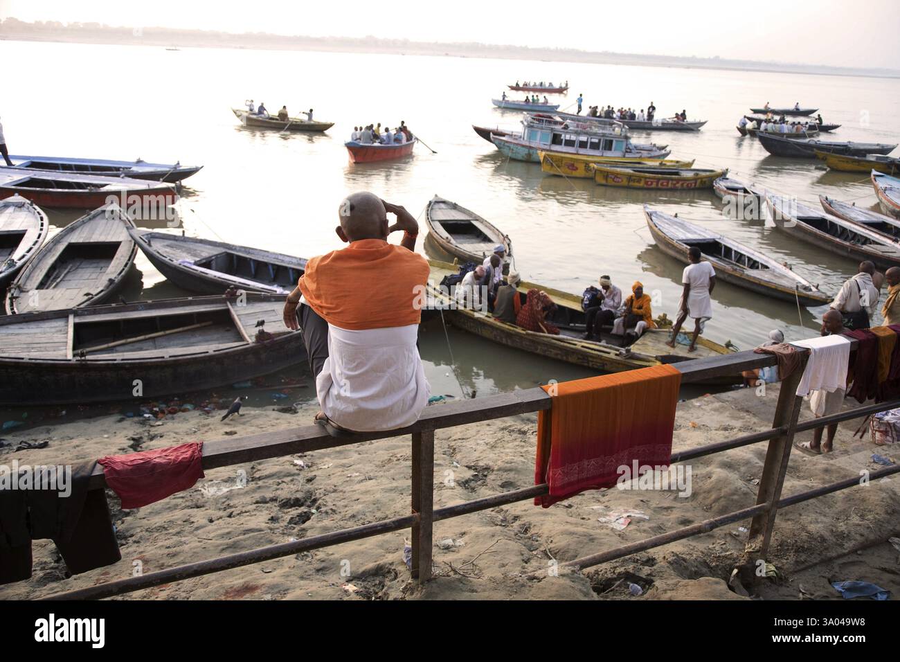 Pilgrim on banks of holy river ganga ganges in Varanasi, Uttar Pradesh ...