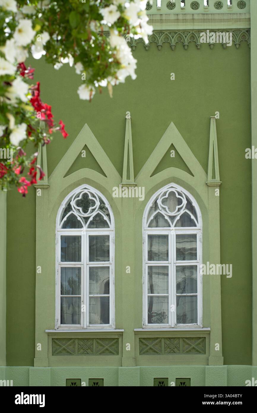 Pointed arched gothic double window on a green building Stock Photo - Alamy