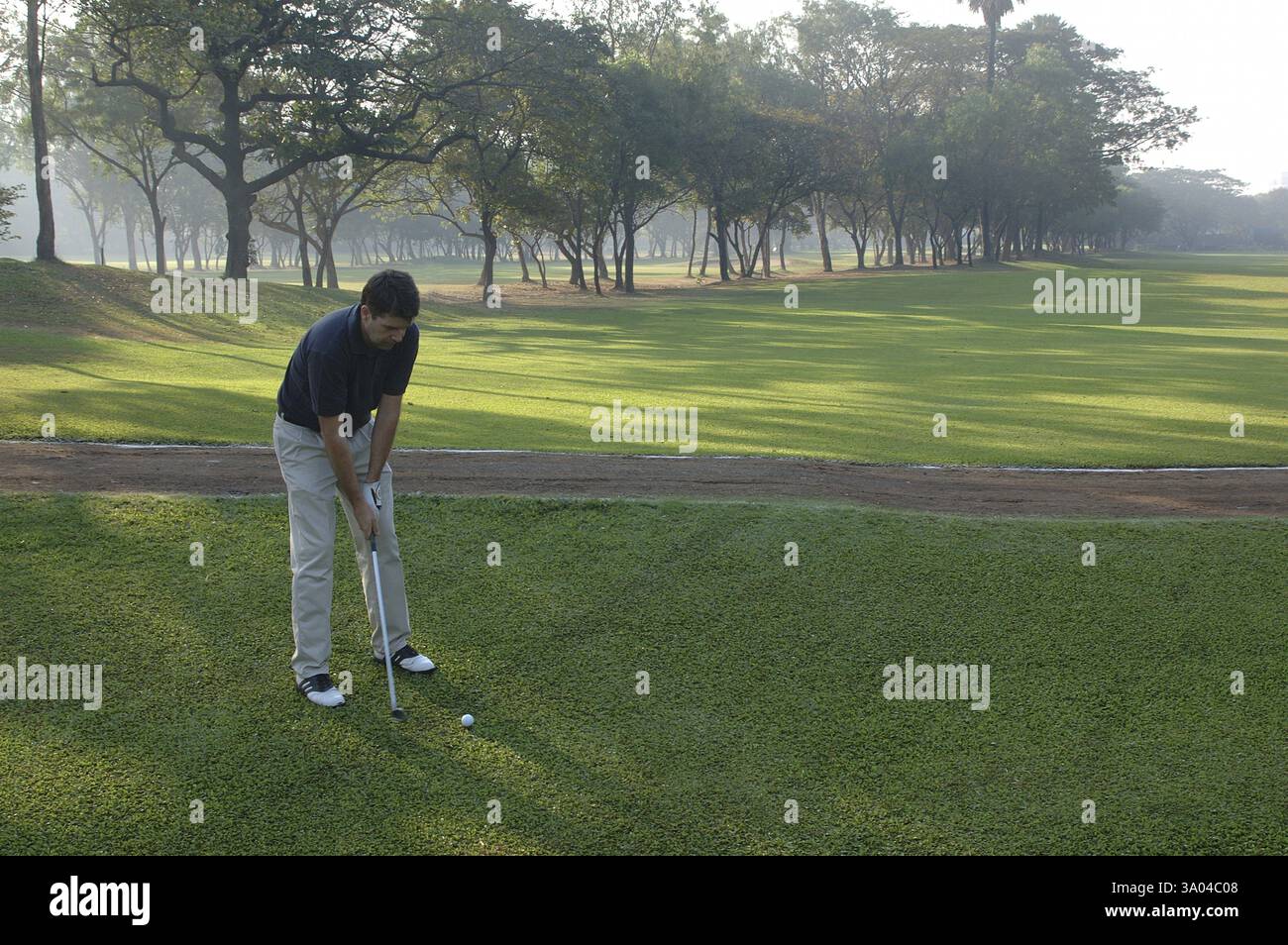 Man playing Golf in position to hit the ball, Golf ball and club, Golf ...