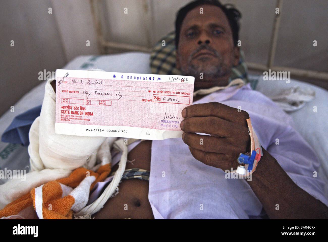 Abdul rashid showing compensation cheque victim of terrorist attack by ...