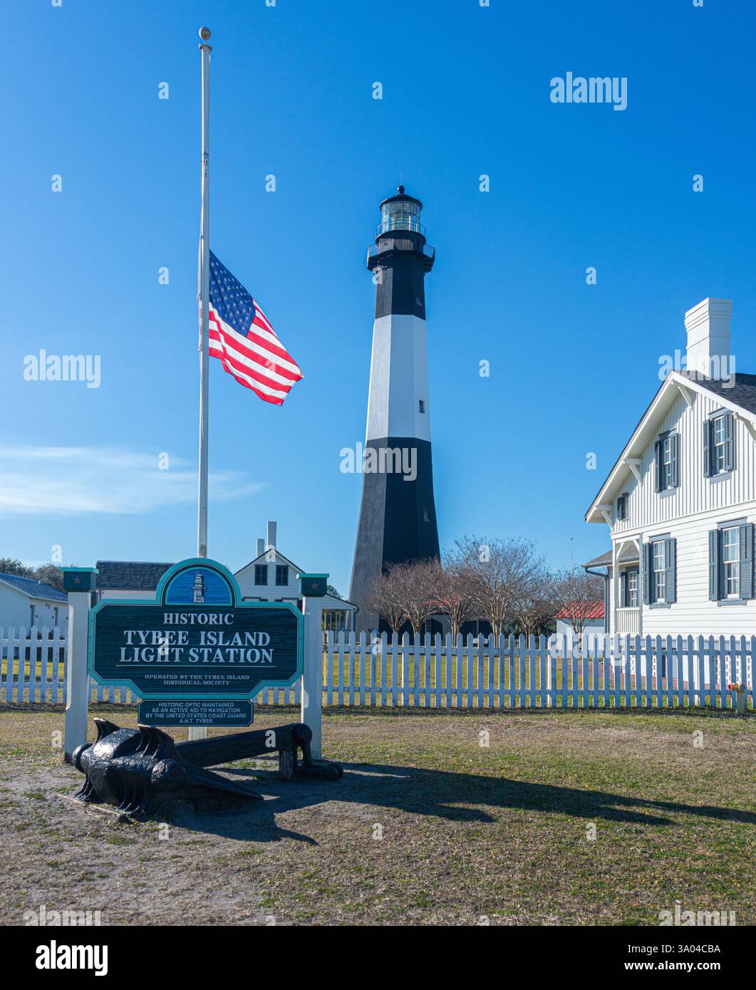 Tybee island lighthouse with American flag at half mast Stock Photo - Alamy