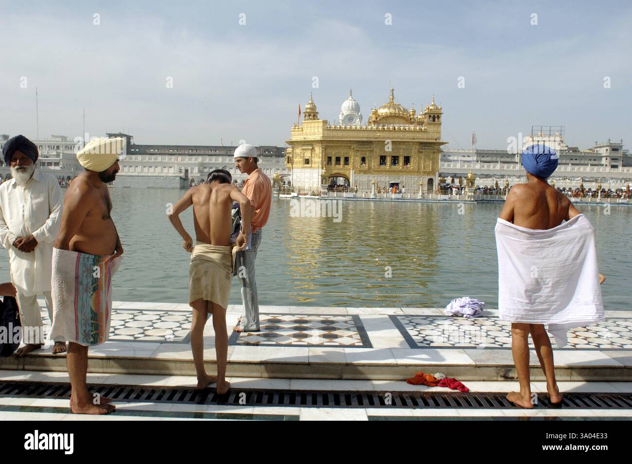 Sikh devotees take a holy dip in Amrit sarovar the lake of nectar ...