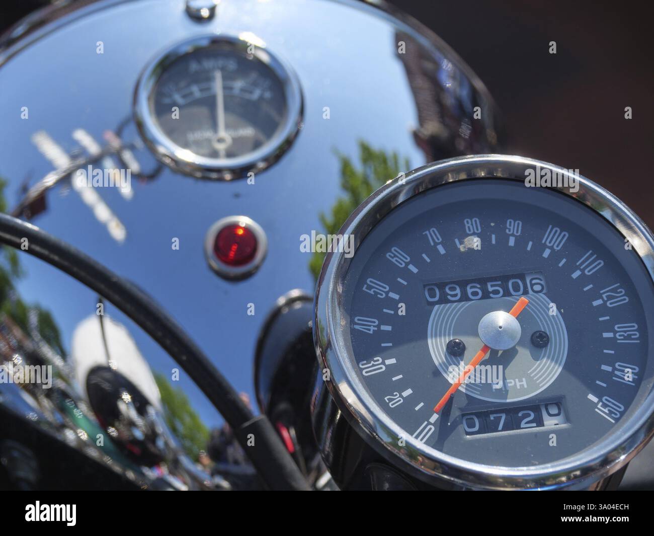 Speedometer on a chrome blue motorbike with reflective background ...