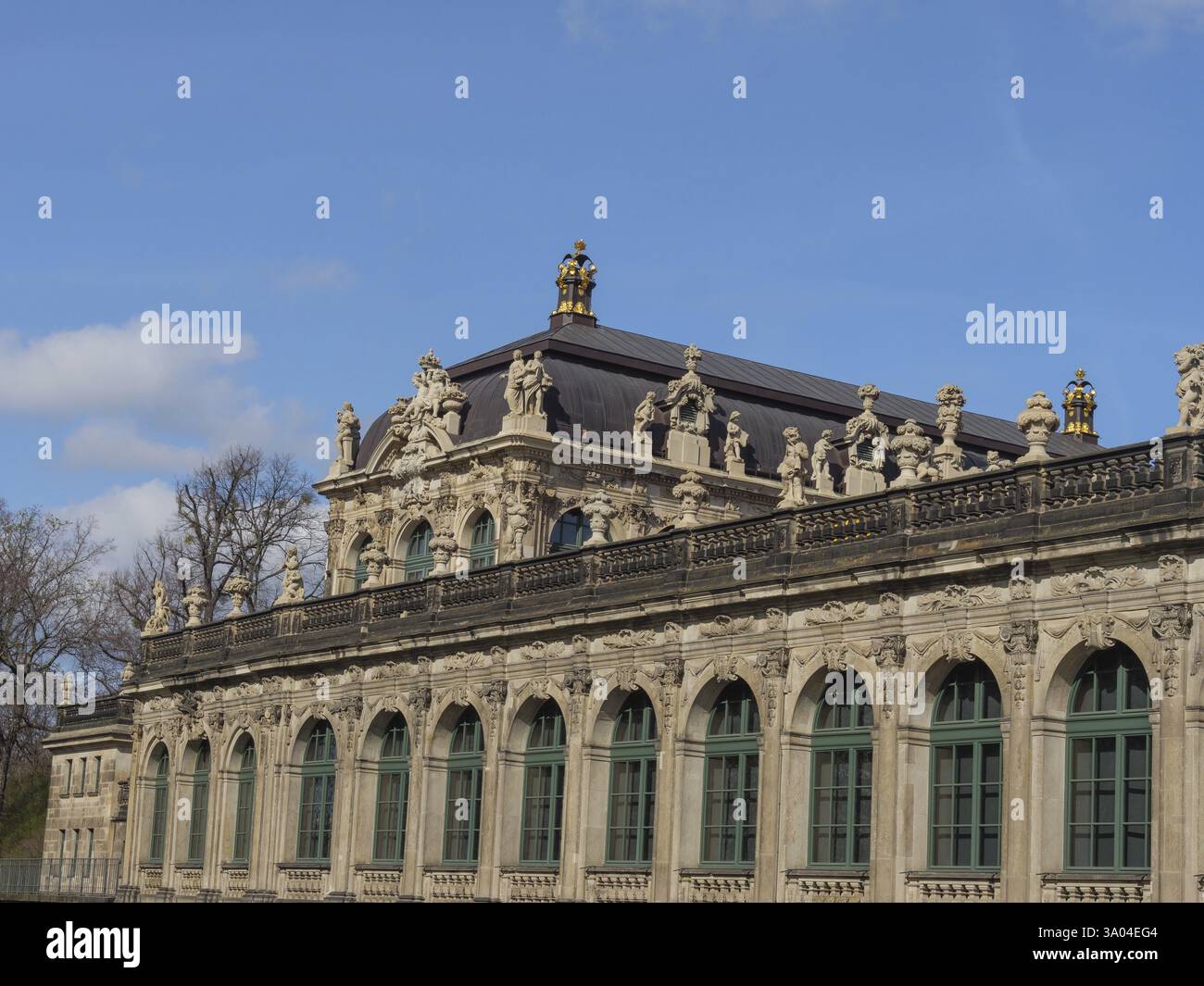 Elongated baroque building with sculptures and numerous windows under a ...