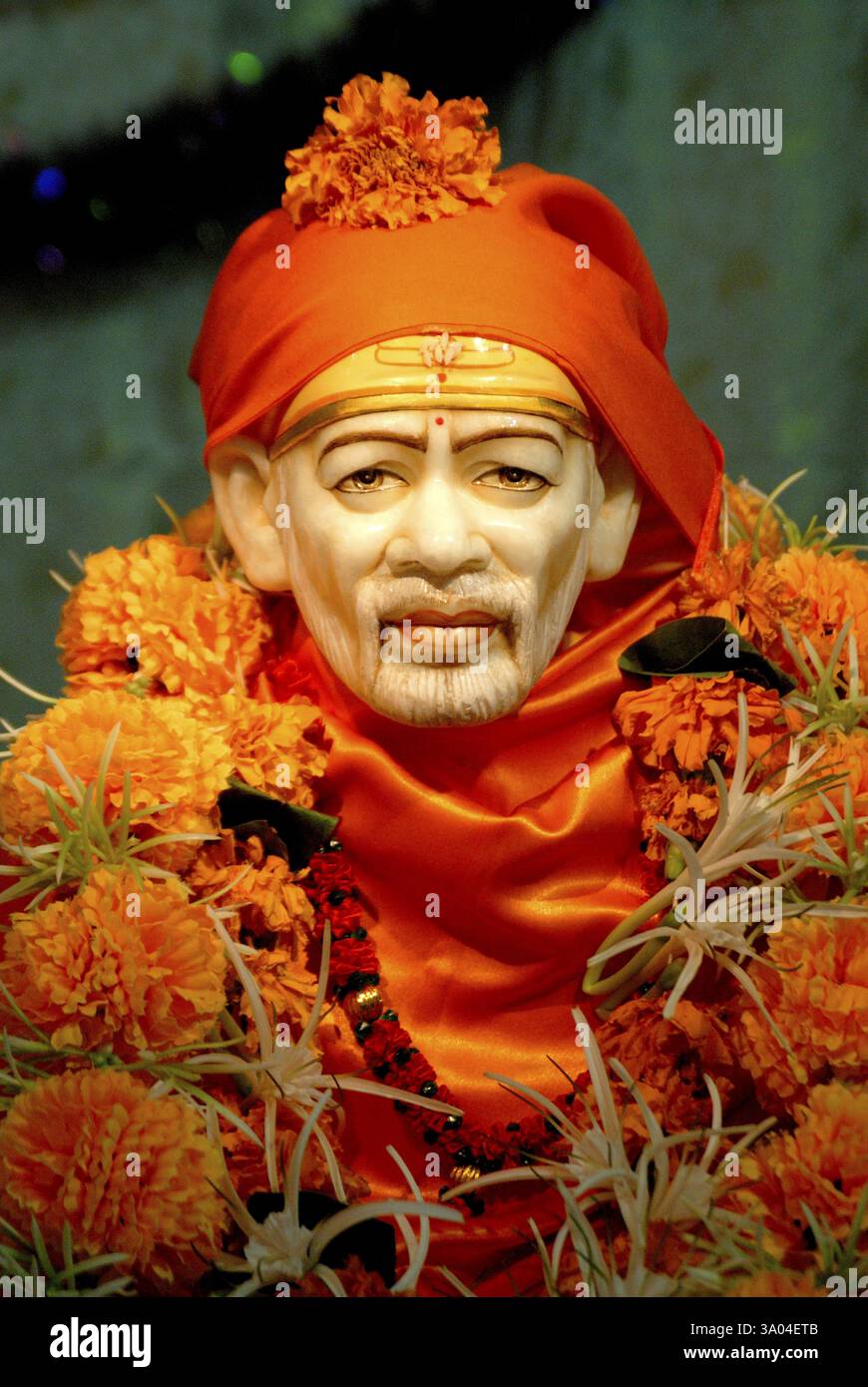 God saint idol of Sai Baba with orange shawl and turban Stock Photo - Alamy