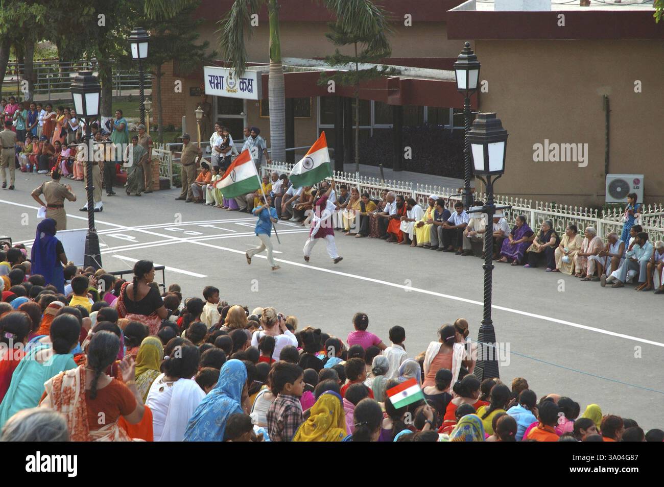 Tourists holding flags of India and running at Wagh border, Amritsar ...