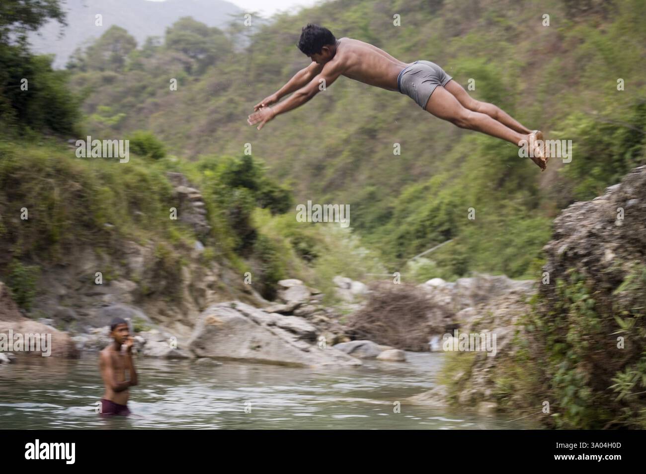 Indian boy jumping in the river, Foothills of Himalaya, Dehradun ...