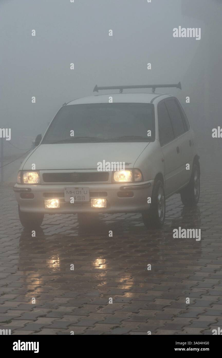 Zen car with headlights and fog lights in mist, Malshej Ghat, Thane ...