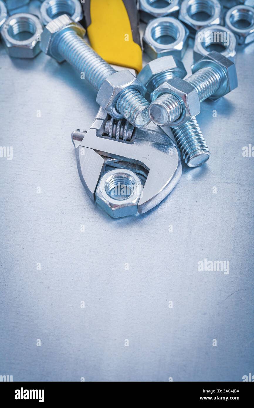 Adjustable key metal bolt details and screw nuts on metallic background ...