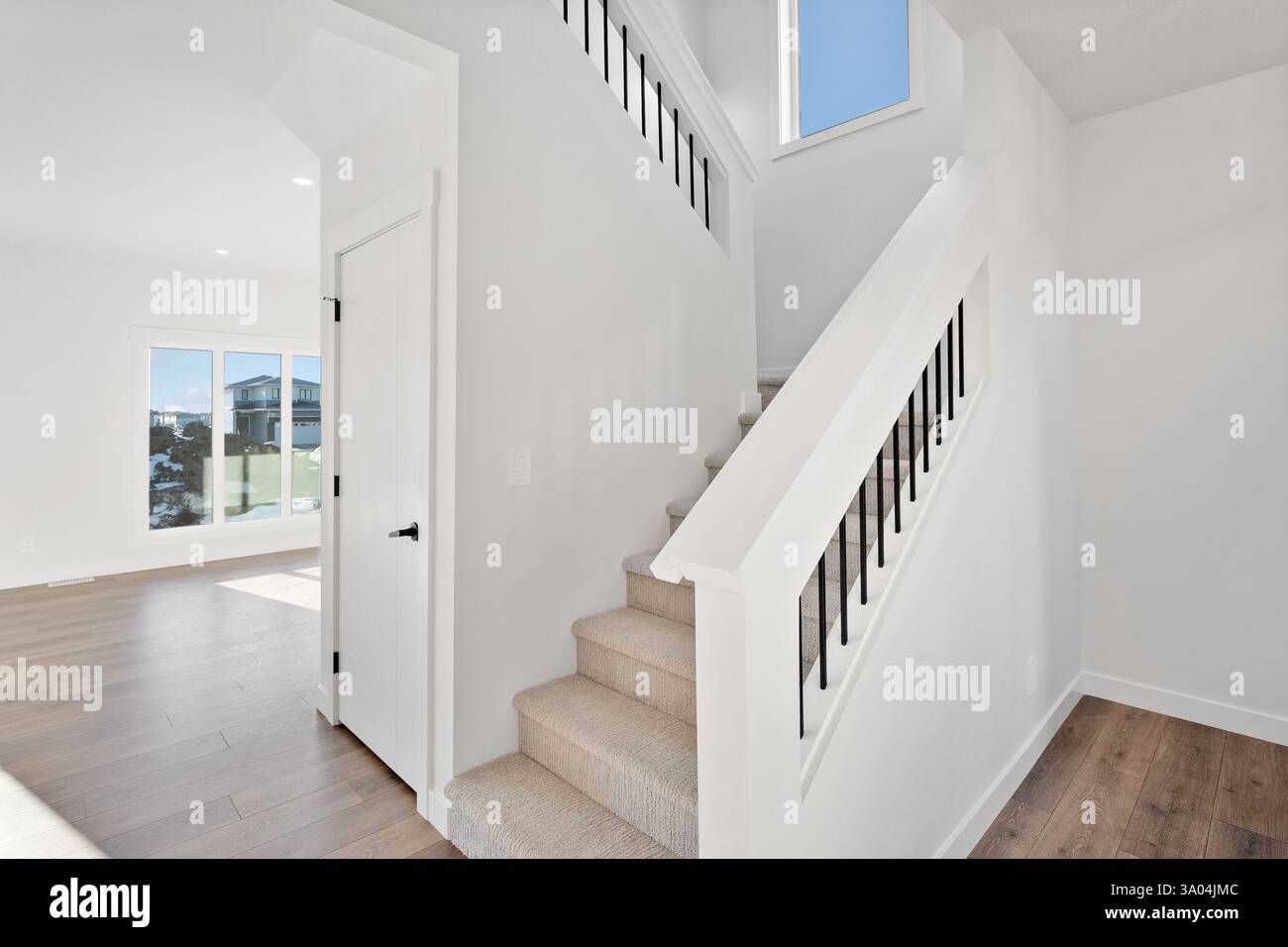 Staircase leading to a second floor with a view of the outside. The ...