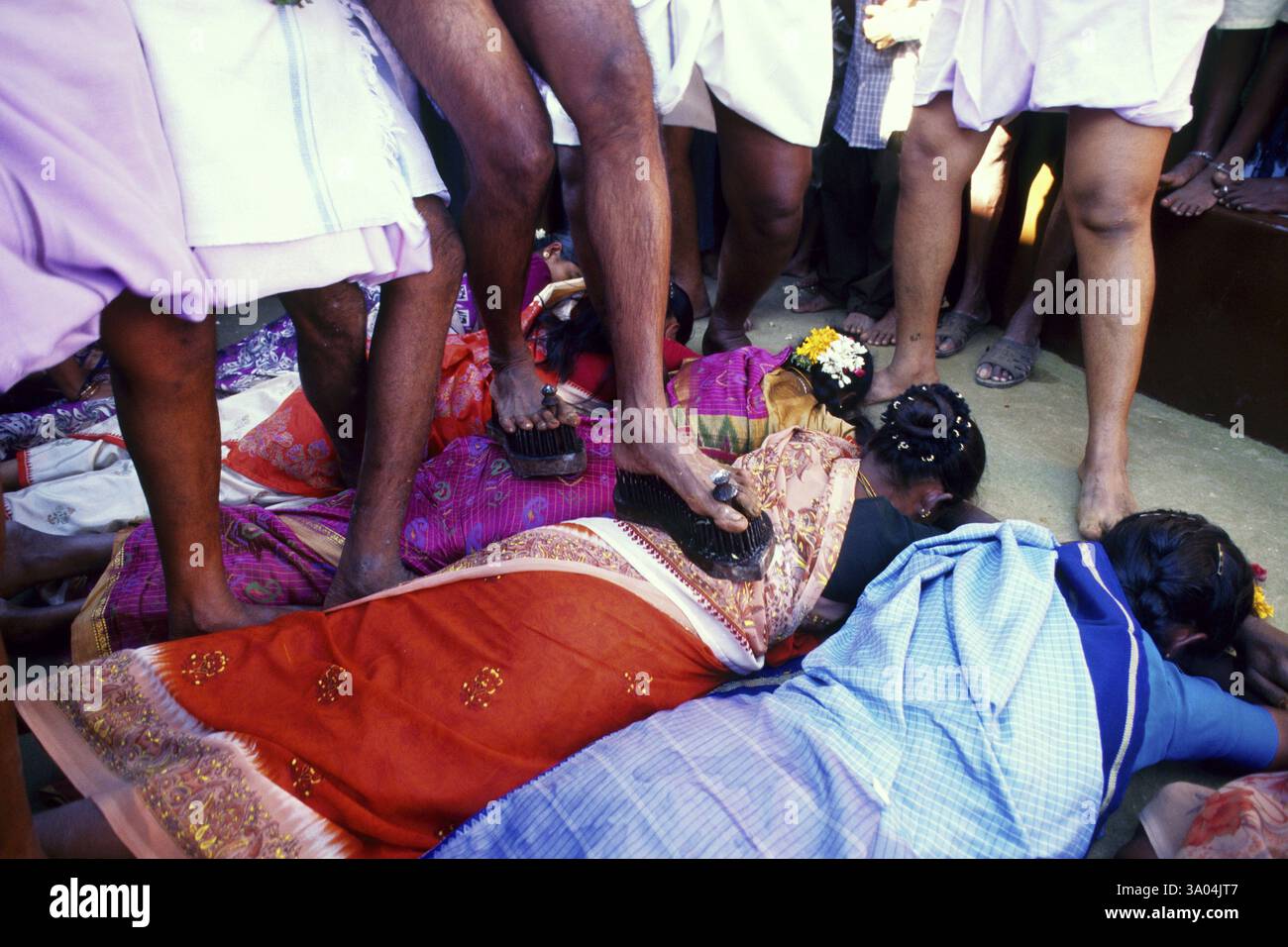 Poojari or priest in khadau walking on women in mahasivaratri at ...