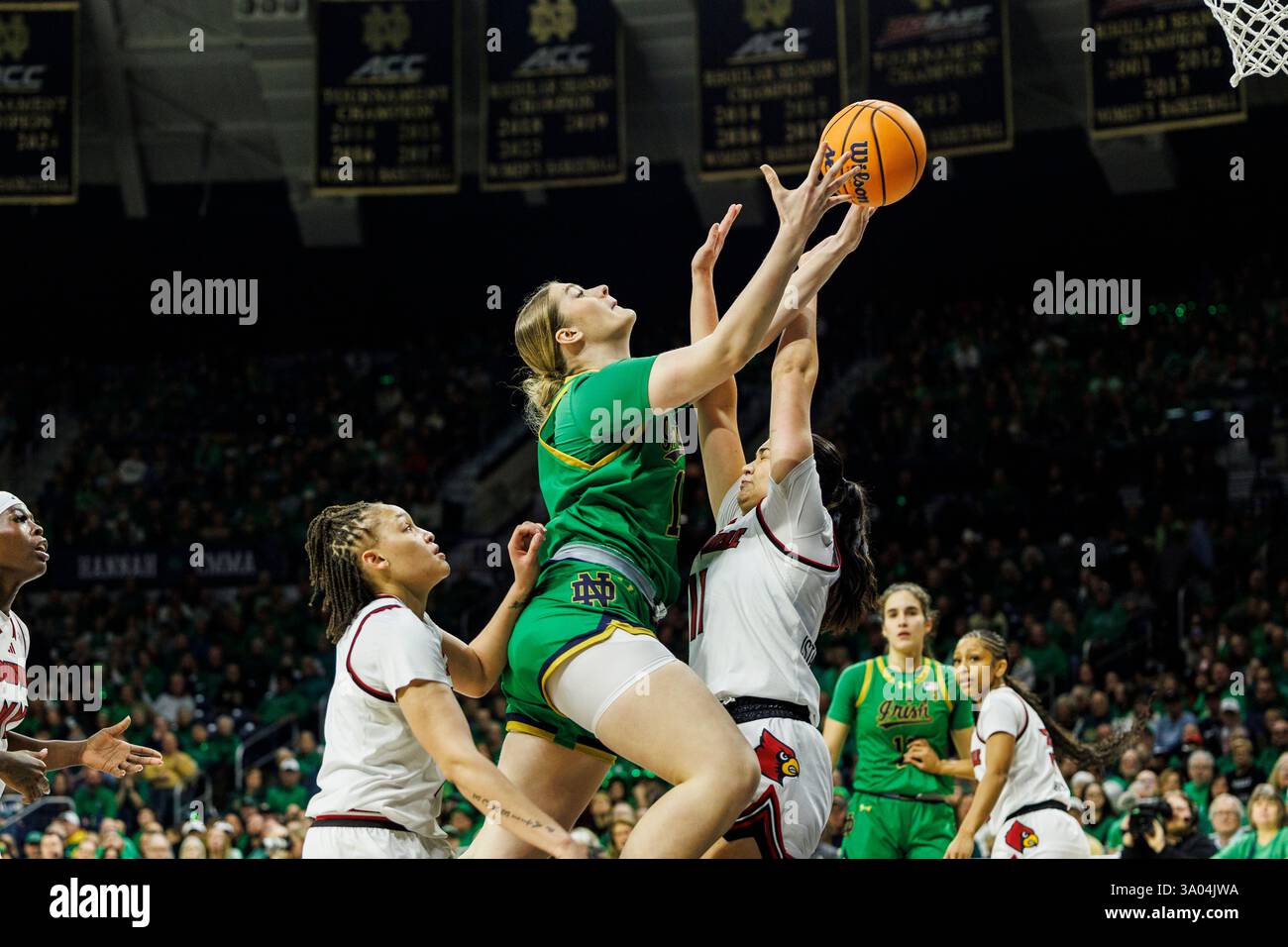 Notre Dame forward Kate Koval, left, shoots over Louisville forward ...