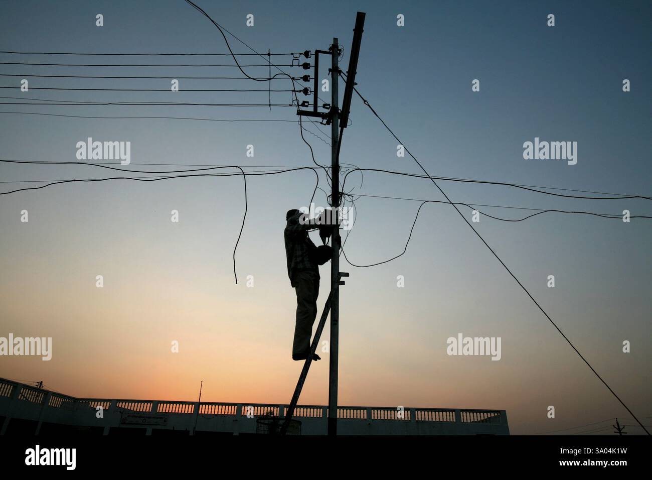 Electricity department personnel working on electric pole in Bhopal ...
