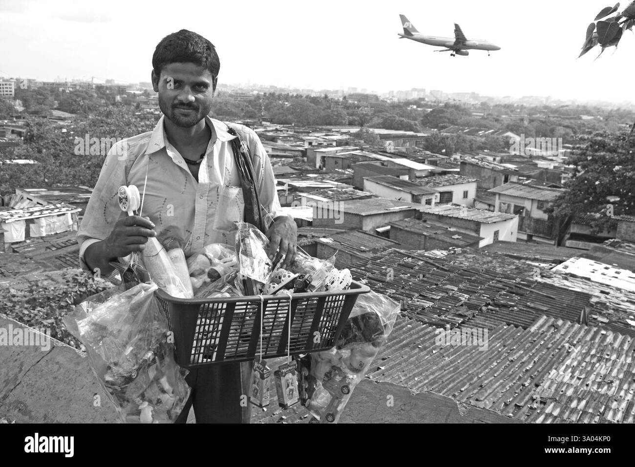 Vendor standing at Kamani Indira Nagar and Kaju Pada slum, Bombay ...