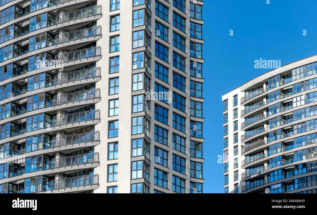 Tall modern building in urban neighborhood. New multi-story condominium ...
