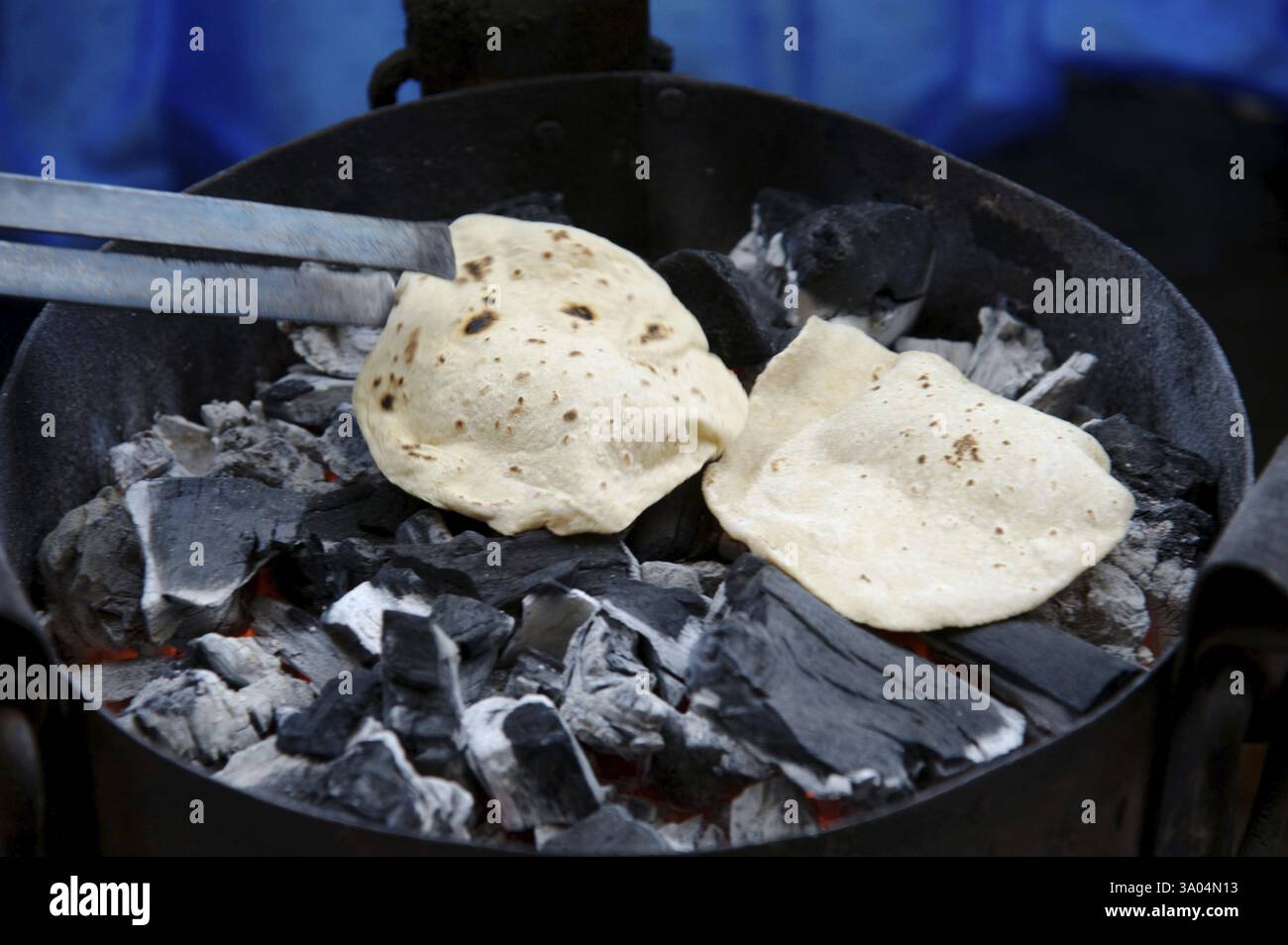 Roti made on hot coals Iron Grate India Asia Stock Photo - Alamy