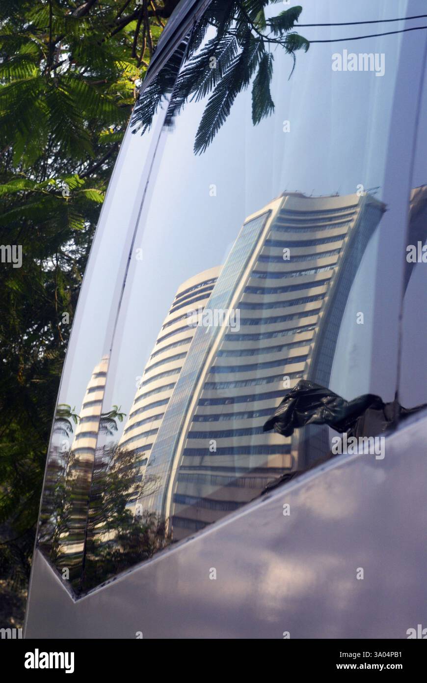 Reflection of Bombay Stock Exchange building in glass of tourist bus at ...