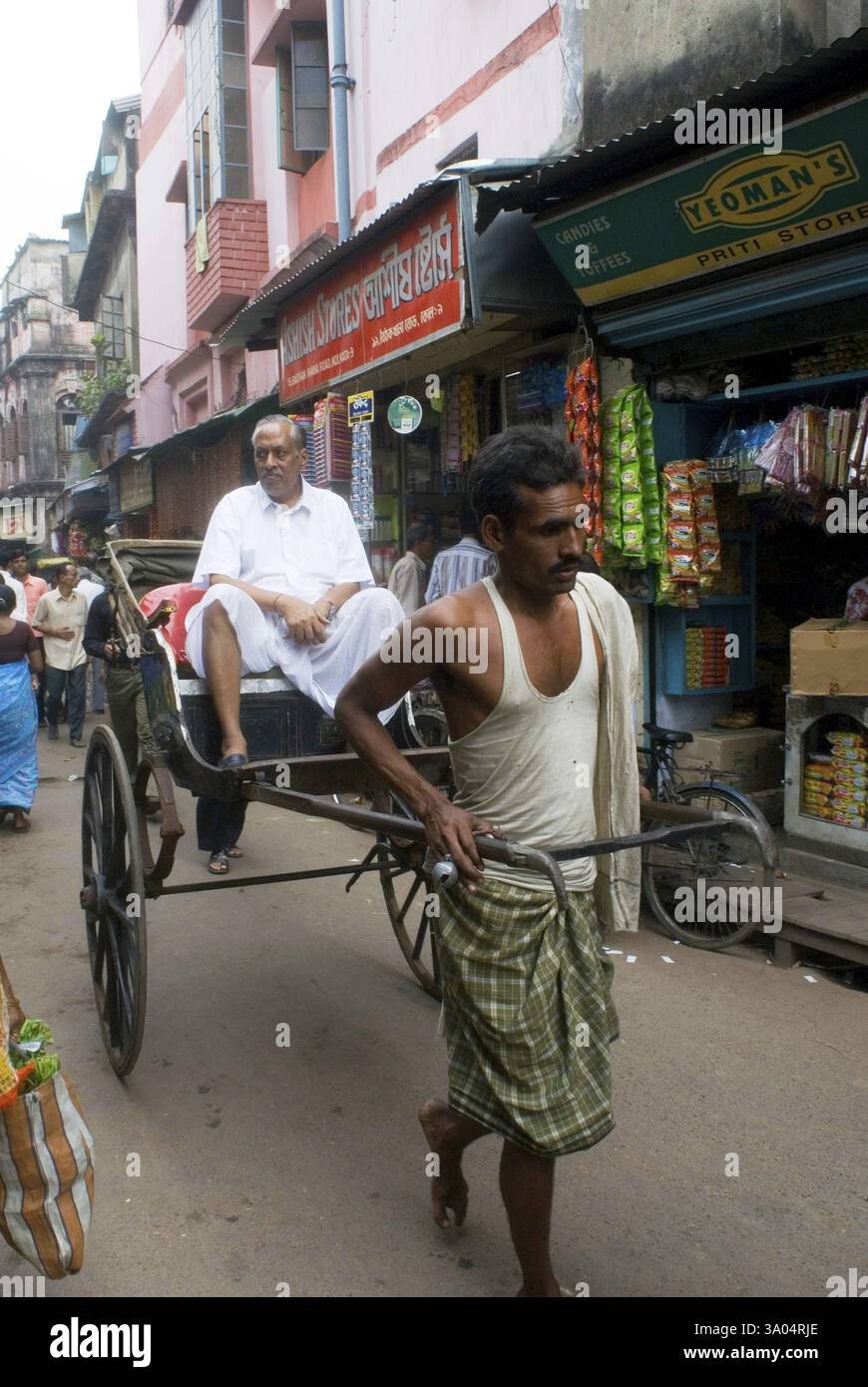 Hand Rickshaw Puller pulling with Passenger, Kolkata, West Bengal ...
