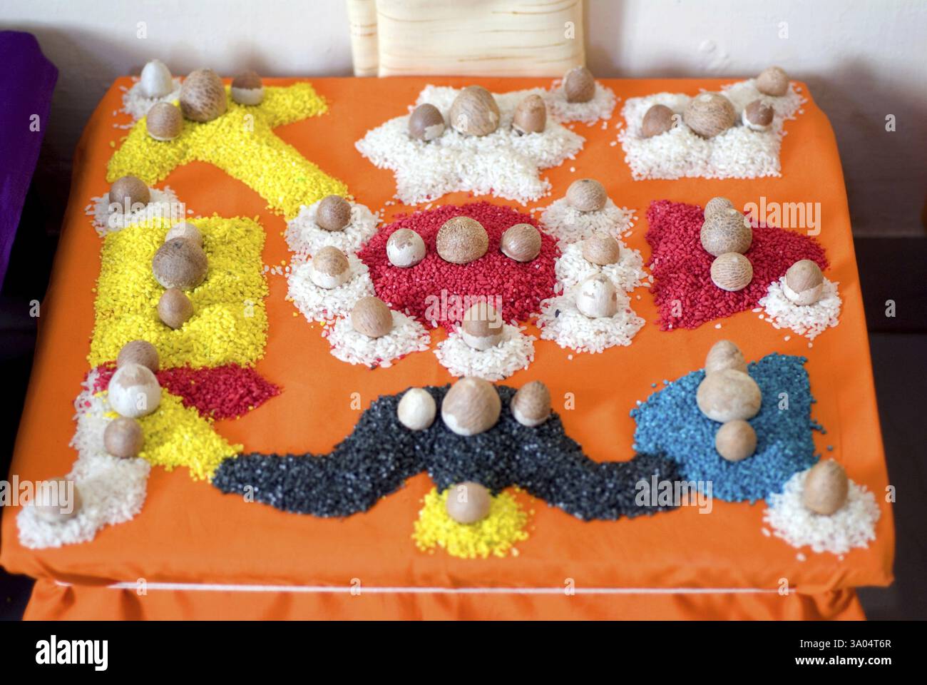 Colourful dyed rice grains betel nuts icon of navagraha nine planets ...