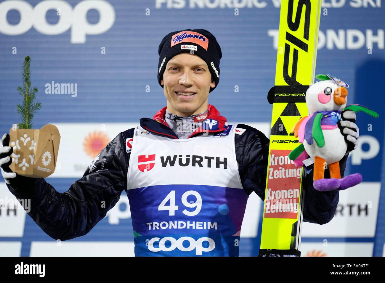 Jan Hoerl, of Austria, poses after winning the bronze medal in the ski ...