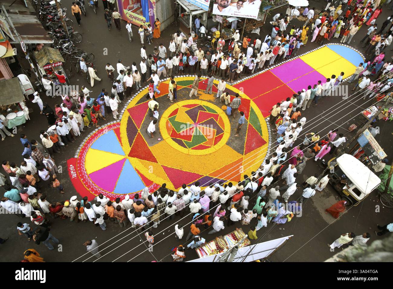 Residents making colourful flower Rangoli on road for immersion ...
