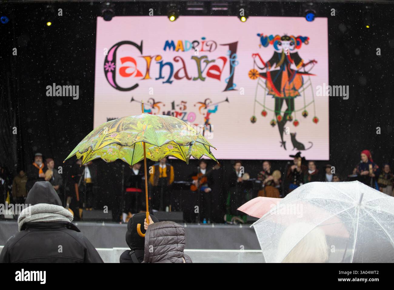 A person raises an umbrella in front of the stage during the "El ...