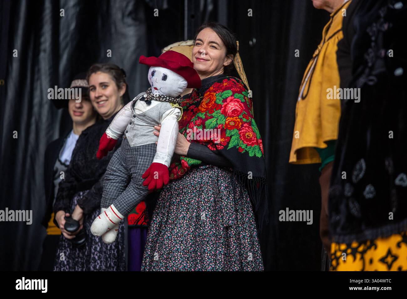 A woman holds a "pelele" (a puppet) during the "El tossing of the ...