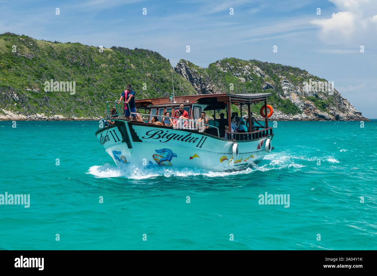 Bigutur II touristic boat loaded with tourists sailing on Guriri cove ...
