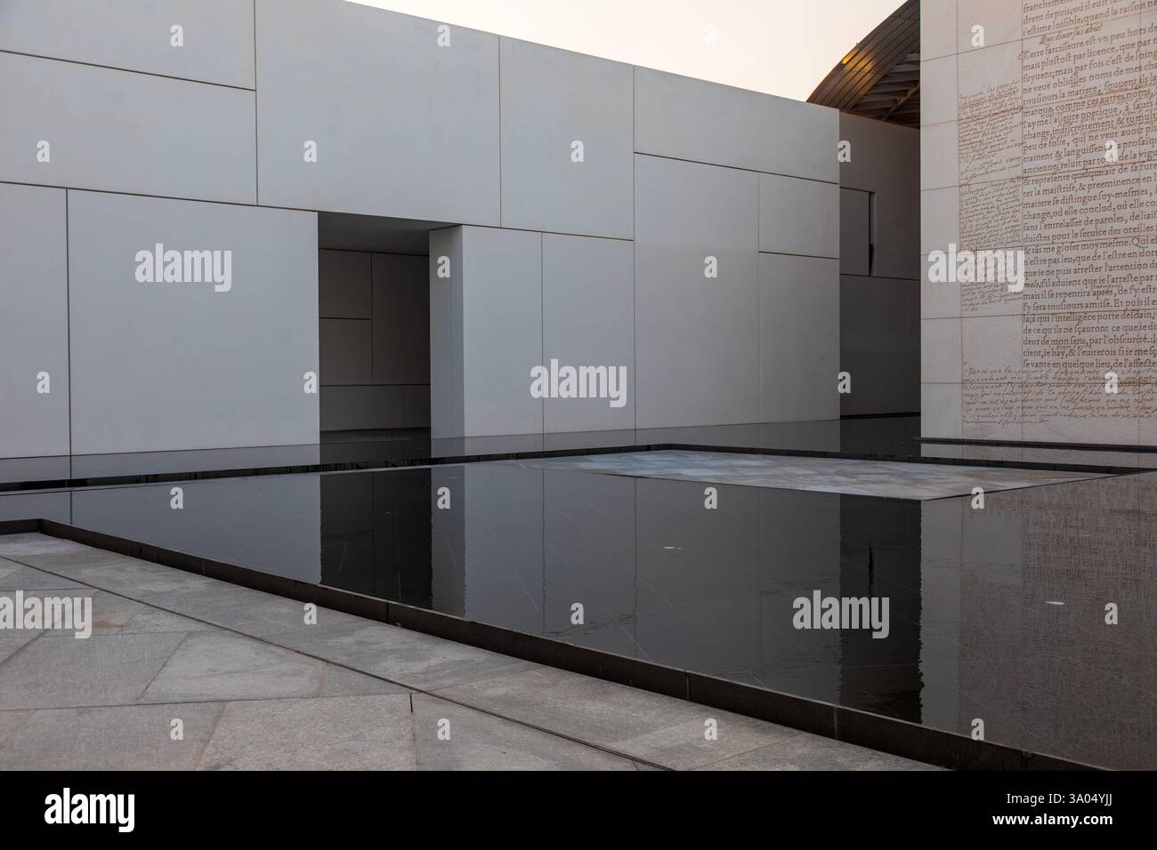 Louvre Abu Dhabi famous museum. Plain white walls surrounding an ...