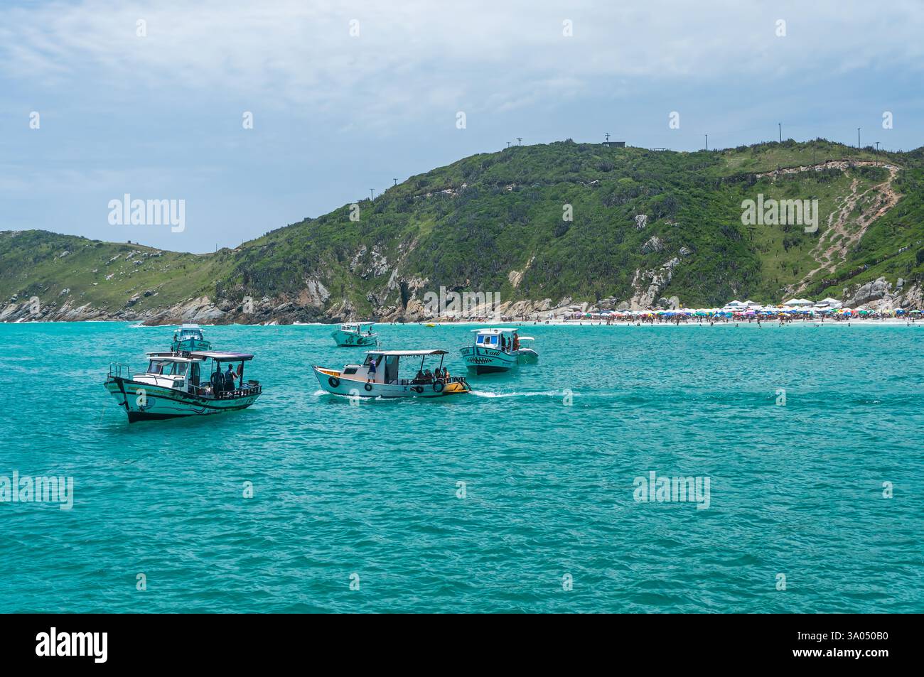 Small schooners and boats sailing at Guriri cove bay turquoise waters ...