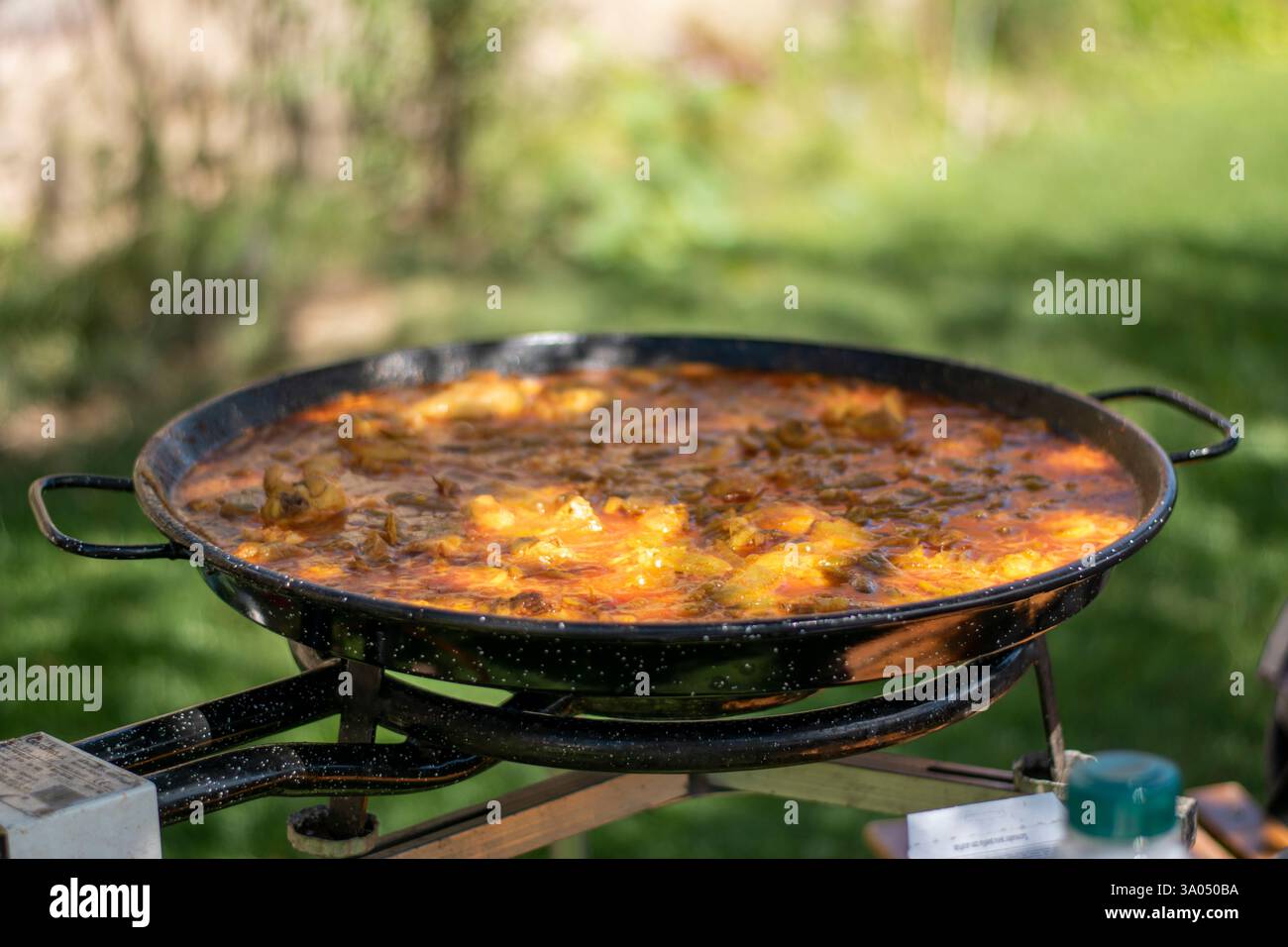Paella: Sunlit Outdoor Culinary Feast Stock Photo - Alamy